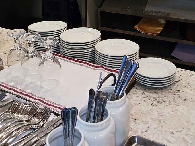 Stacks of plates standing ready for the onslaught of overstuffed creations about to land on them.