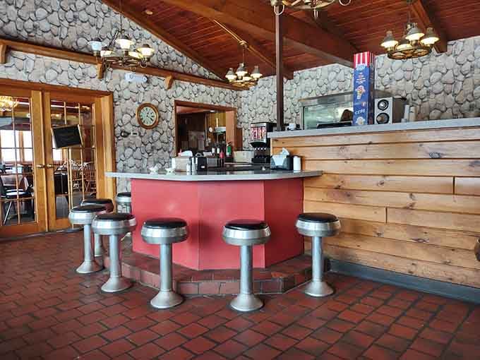 Stone walls and counter seating create the kind of cozy corner where regulars claim their unofficial territories.
