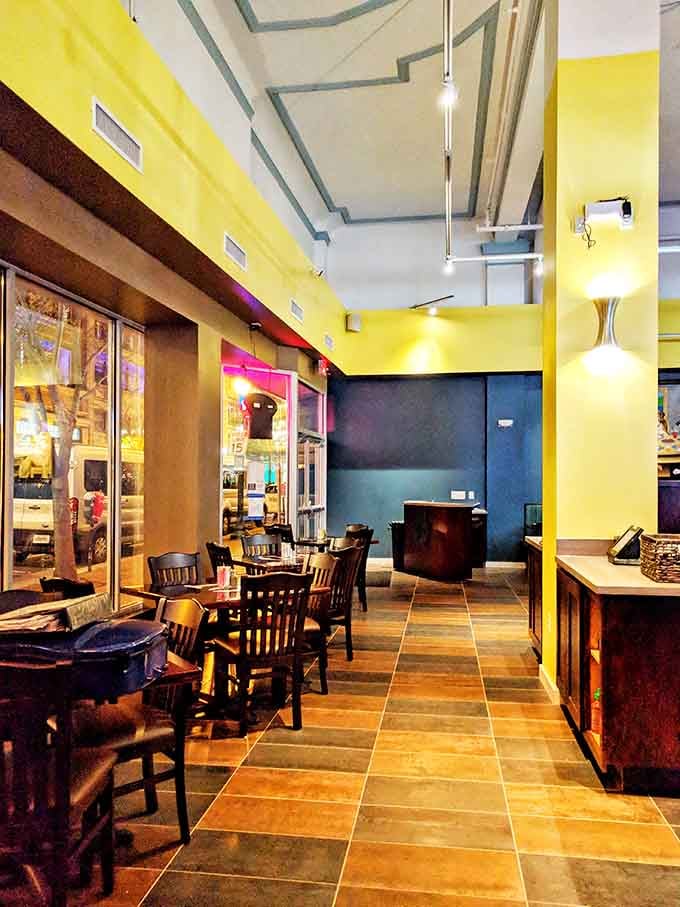 Sunny yellow walls and sleek tile floors create an inviting space that feels both contemporary and wonderfully welcoming to everyone.