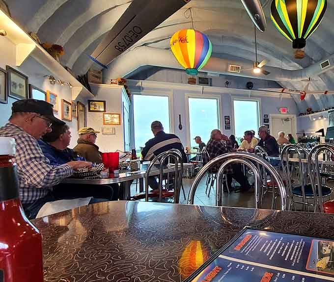 Real people enjoying real food under real model planes, which is somehow more entertaining than most reality television shows.