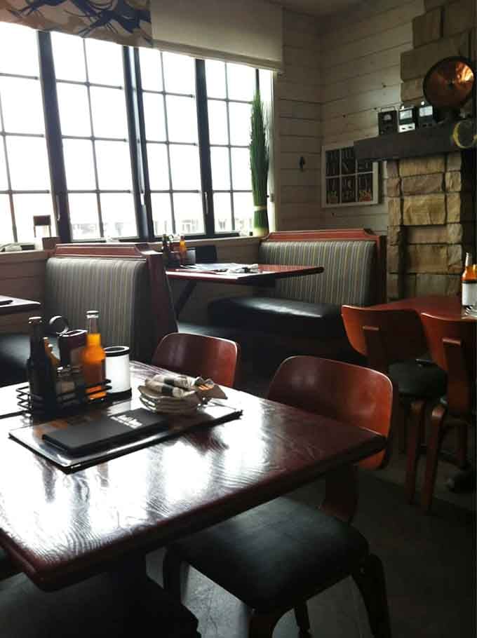 Booth seating by those big windows means you can people-watch while enjoying your meal, multitasking at its finest.