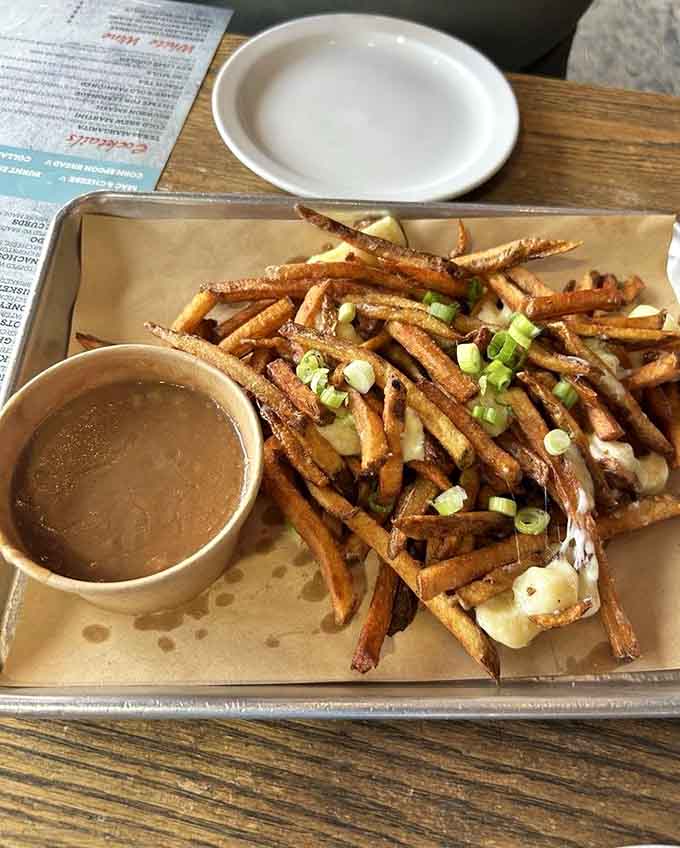 Poutine topped with barbecue goodness and gravy, because sometimes fusion food is exactly what your taste buds have been craving.