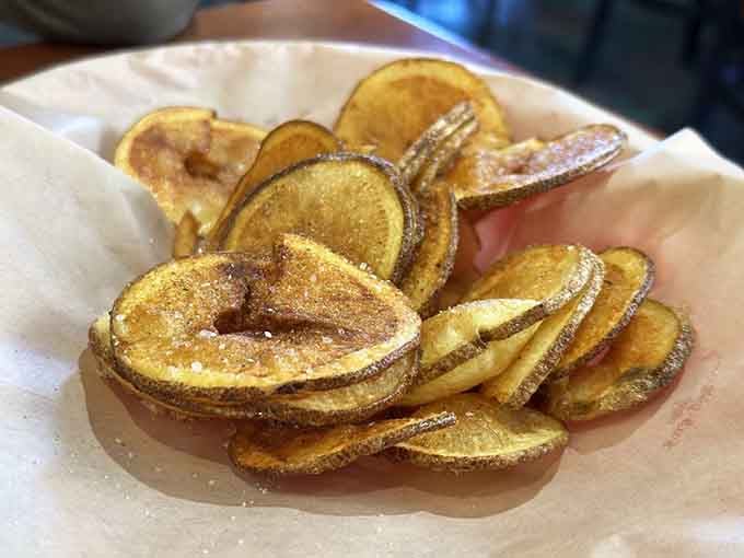Homemade potato chips stacked like crispy, seasoned dominoes ready to tumble straight into your happy place.