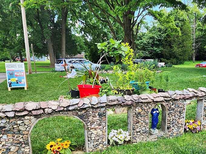 Cheerful flowers peek from stone alcoves, adding splashes of color to the gray masterpiece like nature's own decorating touch.