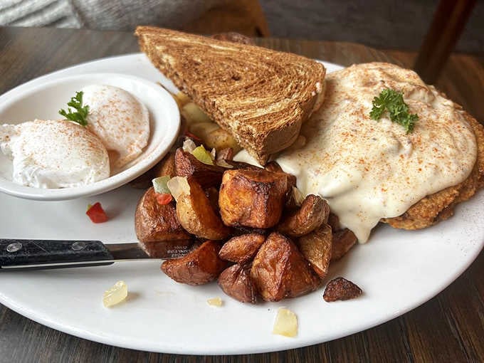 Chicken fried steak smothered in gravy with breakfast potatoes is the kind of plate that requires strategic planning.