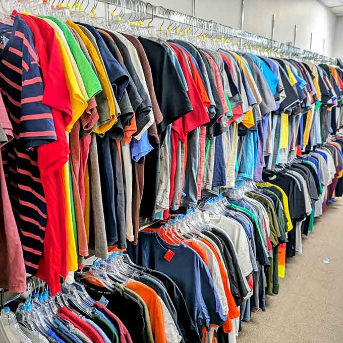 T-shirts organized by color creating a spectrum that makes choosing just one feel nearly impossible to accomplish.