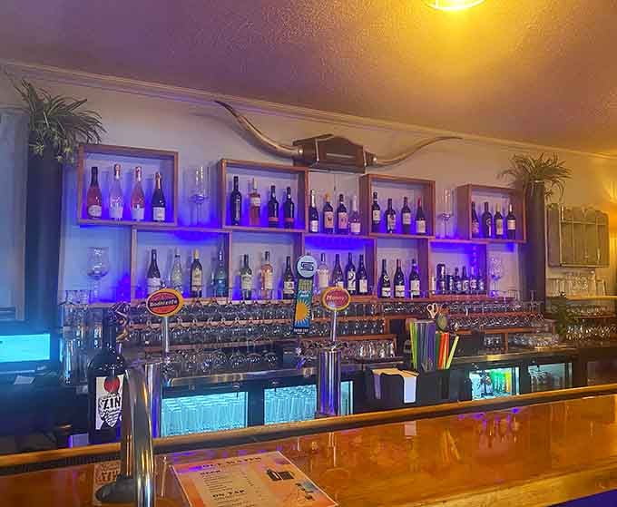 The bar glows with blue lighting and enough bottles to make any brunch feel appropriately celebratory.