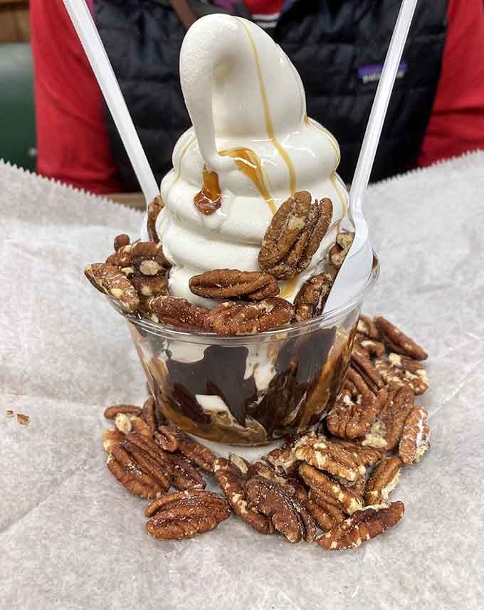 Turtle sundae loaded with pecans and caramel, proving dessert doesn't need to be deconstructed to be delicious.
