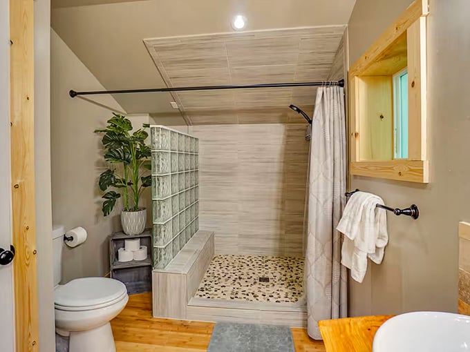 Glass block accents and pebble flooring create a spa-like shower experience worthy of any luxury resort you've visited.