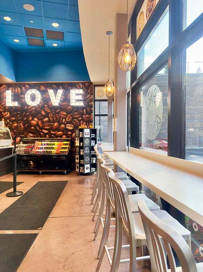 That "LOVE" sign made of coffee beans perfectly captures the vibe here: caffeinated affection for fried dough excellence.