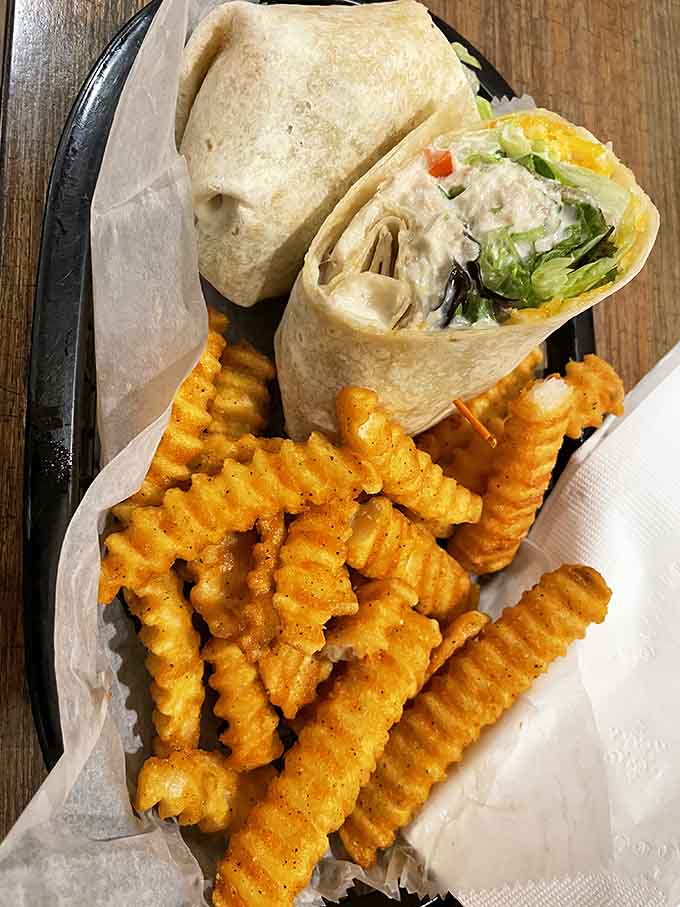 Fresh wraps with crinkle fries offer a lighter option, though "lighter" is relative when everything tastes this incredibly good.