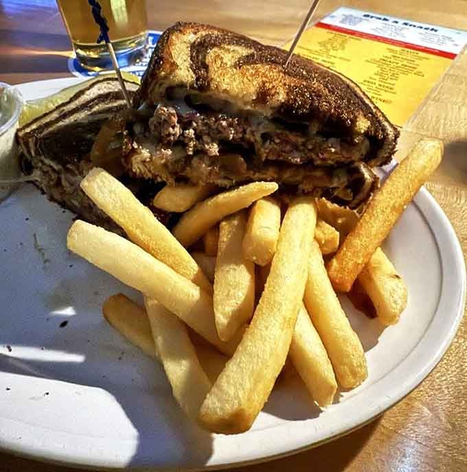 A patty melt on grilled rye with enough cheese to make your cardiologist schedule an intervention, and it's worth it.