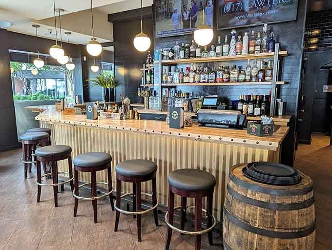 The bar gleams with promise, offering liquid courage for those about to tackle burgers of truly intimidating proportions.