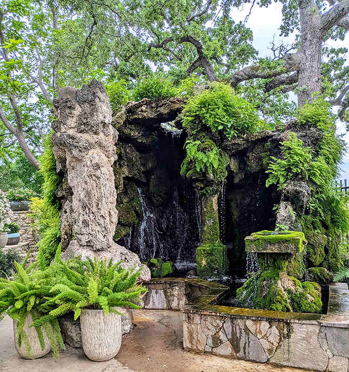 This moss-covered grotto with cascading water looks straight out of a fantasy novel, minus the dragons and questionable plot twists.