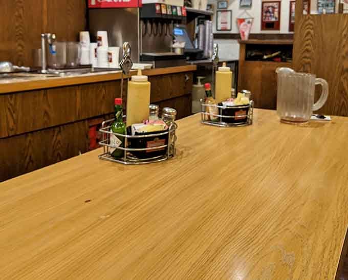 Table condiments in their little carousel, patiently waiting to enhance your meal like tiny flavor superheroes on standby duty.