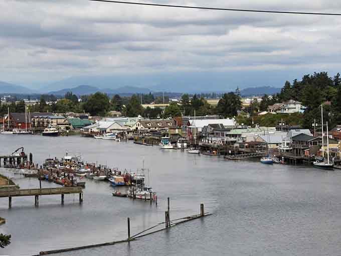 The harbor view showcases La Conner's working waterfront where fishing boats still outnumber pleasure craft.