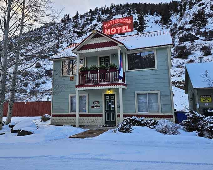 The Matterhorn Motel's vintage sign glows against fresh snow, looking like a postcard from a simpler, more charming era.