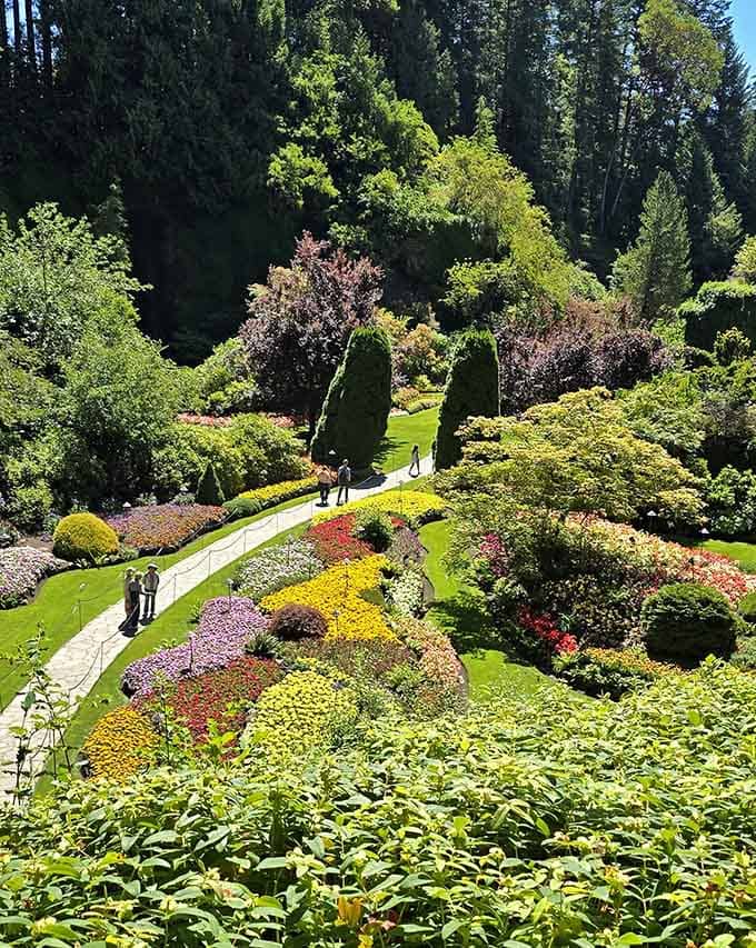Manicured gardens cascade down the hillside in a stunning display of colors, textures, and careful planning.