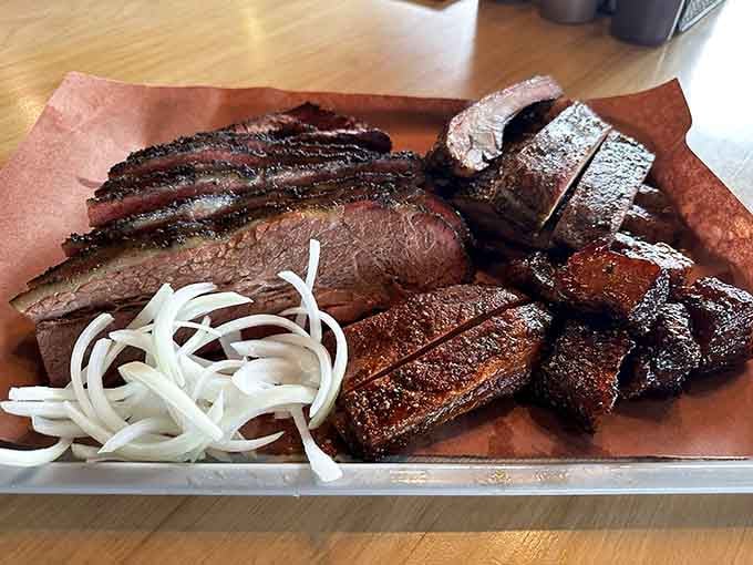 Sliced brisket and ribs arranged like edible art, proving beauty and deliciousness aren't mutually exclusive concepts here.