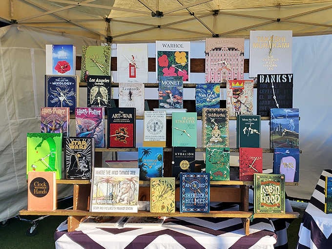 Books stacked like a literary buffet where Warhol and Harry Potter somehow make perfect sense as neighbors together.