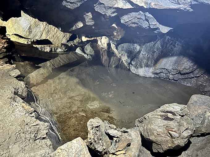 The mysterious underground stream reflects cavern ceilings, its source and destination still puzzling scientists to this day.