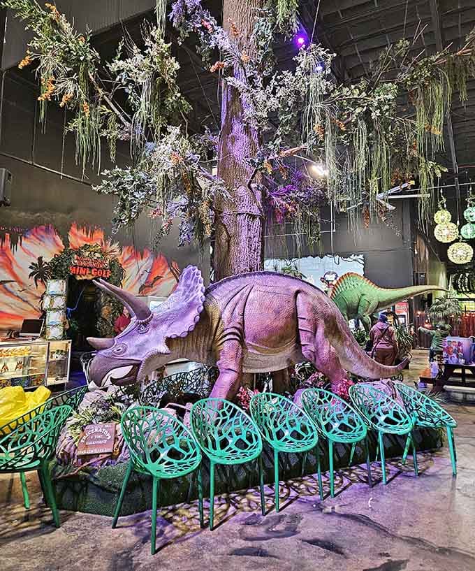 A purple triceratops stands guard near turquoise seating, proving dinosaurs and design can absolutely coexist beautifully together.