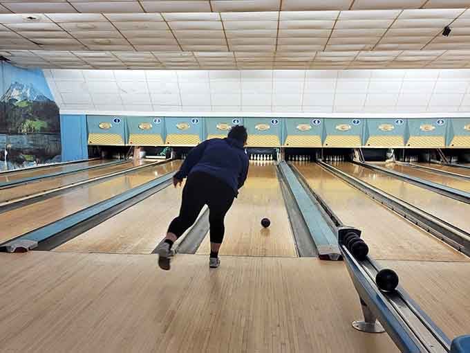 Perfect form captured mid-release, proving that grace and bowling aren't mutually exclusive after all, despite what your knees say.