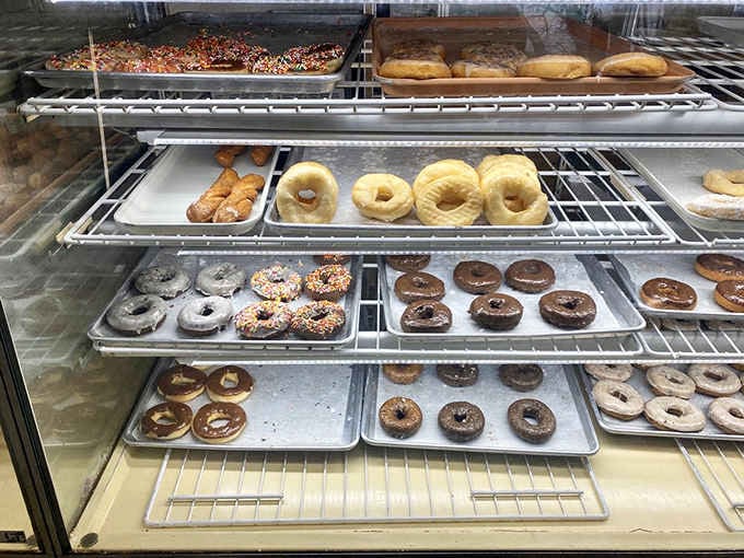 Display cases stocked with fresh donuts at Luke's Donut Shop Inc, where the morning rush means business and sells out fast.