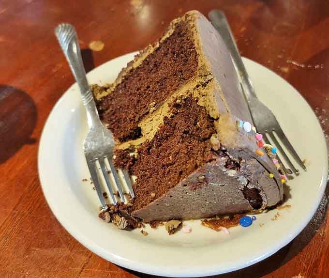 Towering layers of moist chocolate cake with rich frosting make every calorie worth celebrating without a single regret.