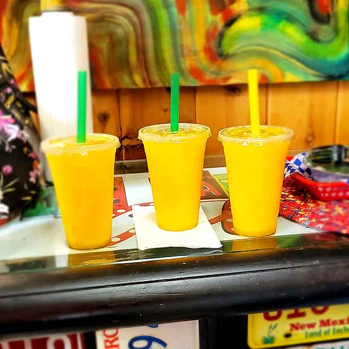 Three sunshine-yellow drinks lined up like liquid happiness waiting to happen.