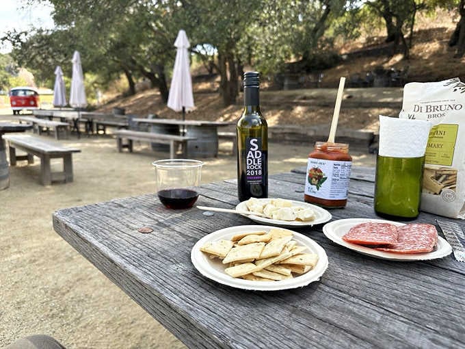 Crackers, cheese, salami, and wine under oak trees is basically the definition of civilized outdoor dining.