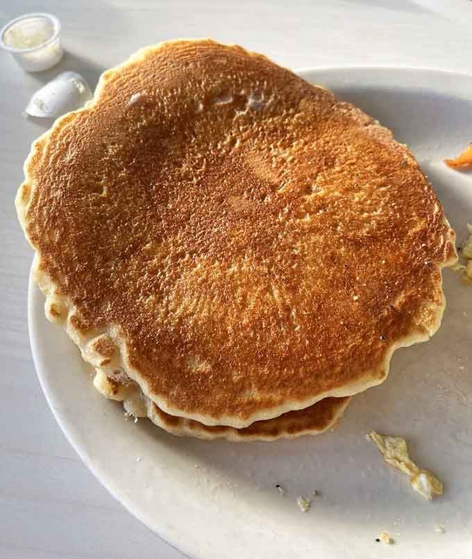 These golden pancakes are so perfectly round and fluffy, they could be the poster children for breakfast done right.