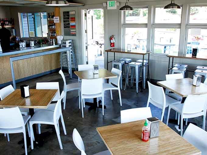 Clean, bright interior where white chairs and wood tables keep things casual and welcoming.