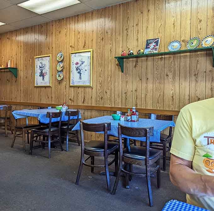 Decorative plates and rooster artwork on wood paneling create that homestyle charm that makes you feel like family before you've even ordered.