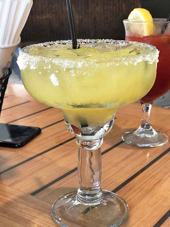 A proper margarita with a salt rim big enough to see from space, because beach days require serious refreshment.