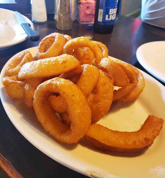 Onion rings piled high enough to require architectural planning and serious commitment to finish them all.