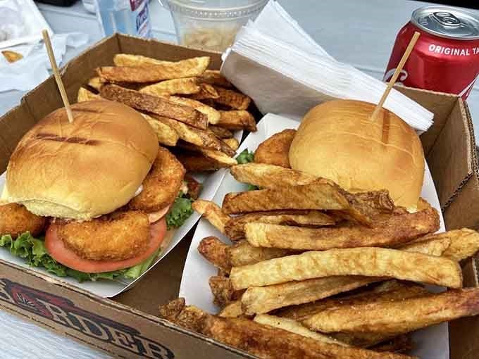 A takeout box packed with enough fries and burgers to fuel a small road trip adventure.