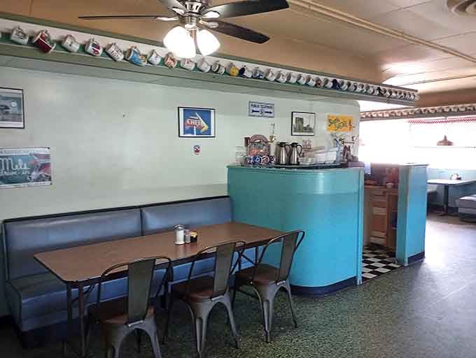 Coffee mugs line the ledge like trophies celebrating decades of caffeinated conversations and community connections.
