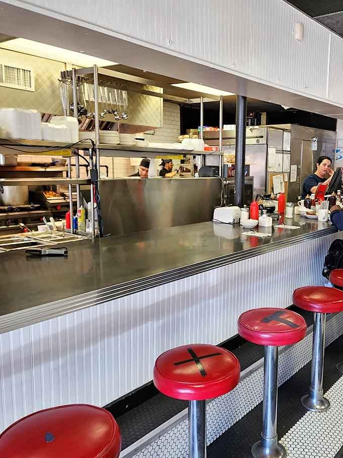 Counter seating offers front-row views of breakfast theater, where eggs and hash browns take center stage daily.