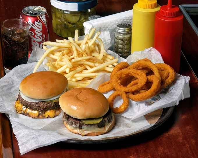 This spread represents everything right with American comfort food: burgers, rings, fries, and zero pretension whatsoever.
