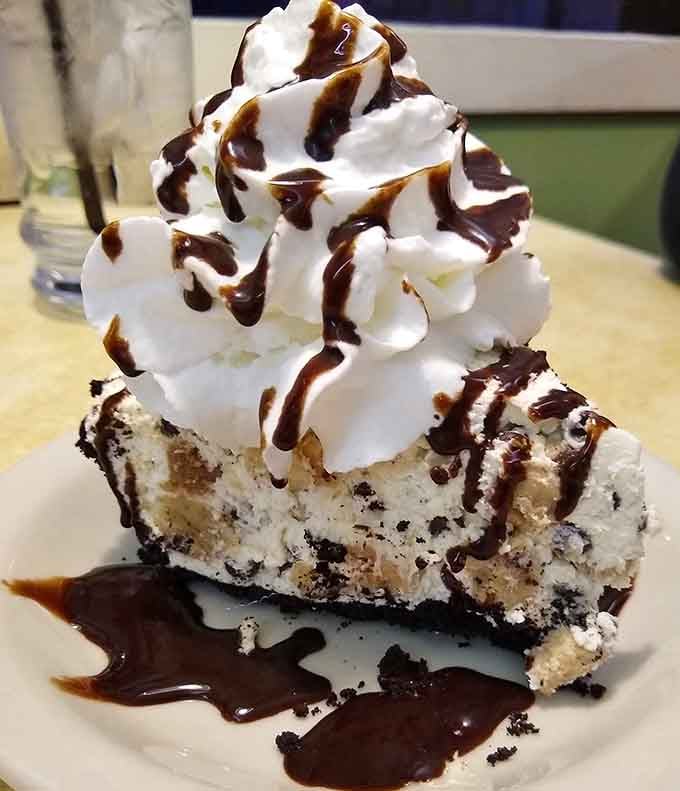 This towering slice of Oreo cheesecake drizzled with chocolate proves that some desserts are worth loosening your belt for immediately.