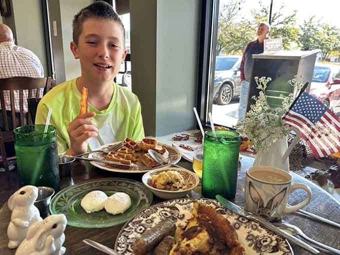 Nothing captures pure breakfast joy quite like a kid with aebleskivers, waffles, and that "I'm in heaven" expression.