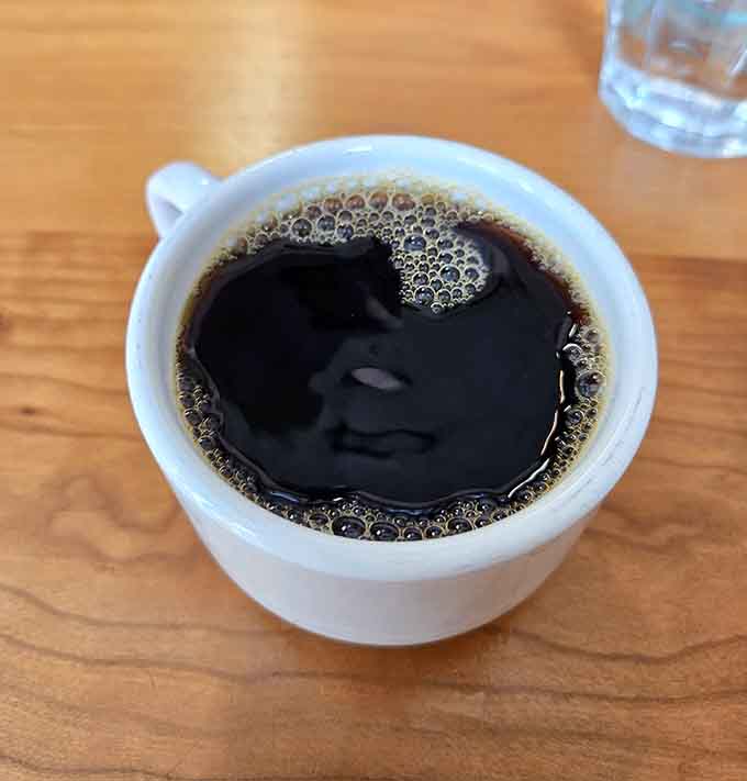 Simple black coffee in a white cup, proving sometimes the best things need no fancy introduction.