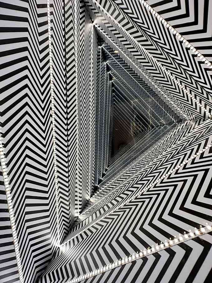 This black and white tunnel spirals endlessly inward, proving that sometimes the rabbit hole is actually a triangle hole.