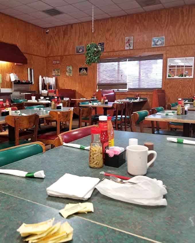 Wood paneling and mismatched chairs create that authentic, lived-in feel where everyone's welcome at the table together.