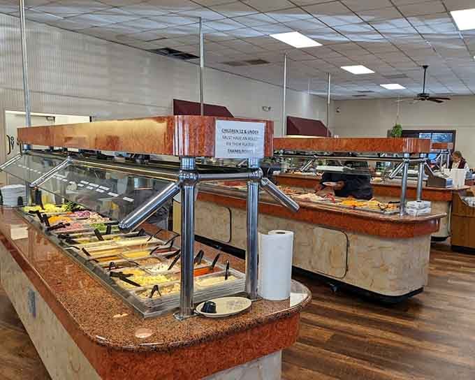 A spacious buffet setup packed with comfort food stations, ready for anyone craving a serious Southern feast.