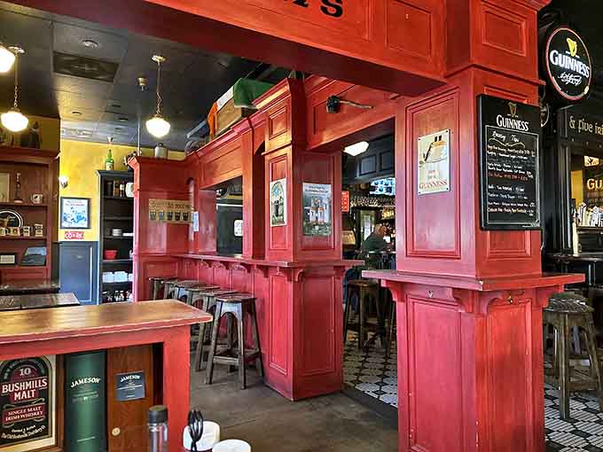Those red high-top tables and Guinness memorabilia create an authentic pub vibe that feels both festive and welcoming.