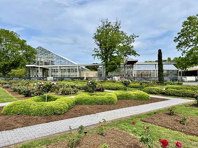 The greenhouse complex gleams in the sunlight, housing tropical treasures that thrive regardless of Virginia's weather outside.