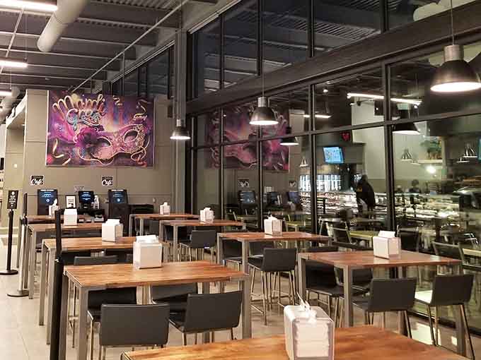 Modern seating meets warm wood tones, creating a space where lingering over coffee and pastries feels practically mandatory.