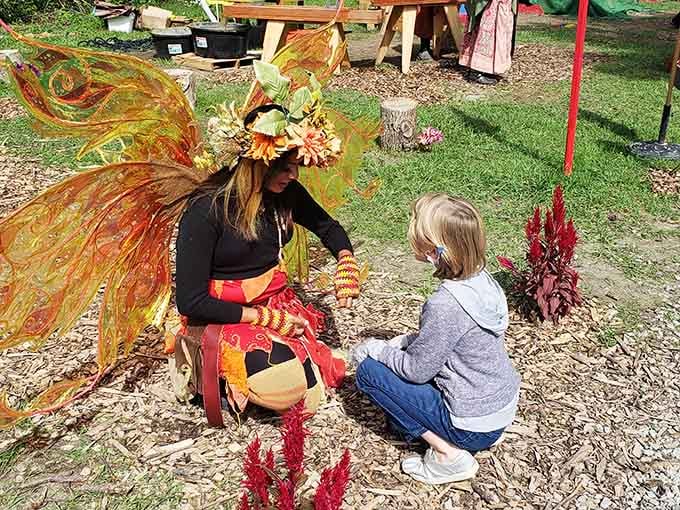 Gossamer wings shimmer as a fairy shares secrets with a young visitor in this enchanted corner.